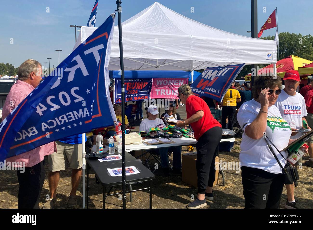 A booth displays flags for former President Donald Trump at Iowa State ...