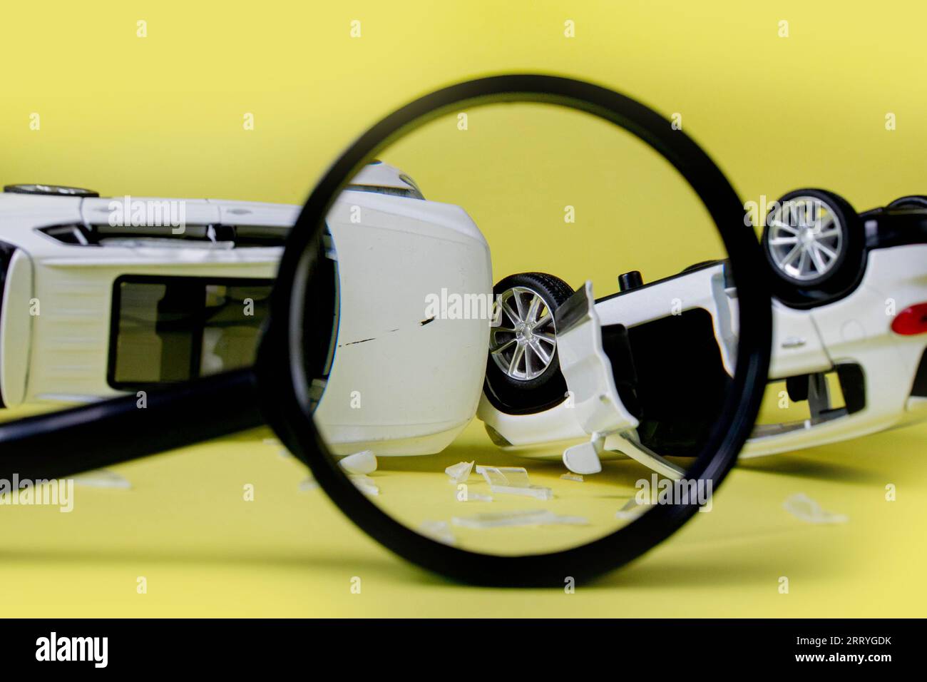 Two mini toy car crash on yellow background, incident, car traffic ...