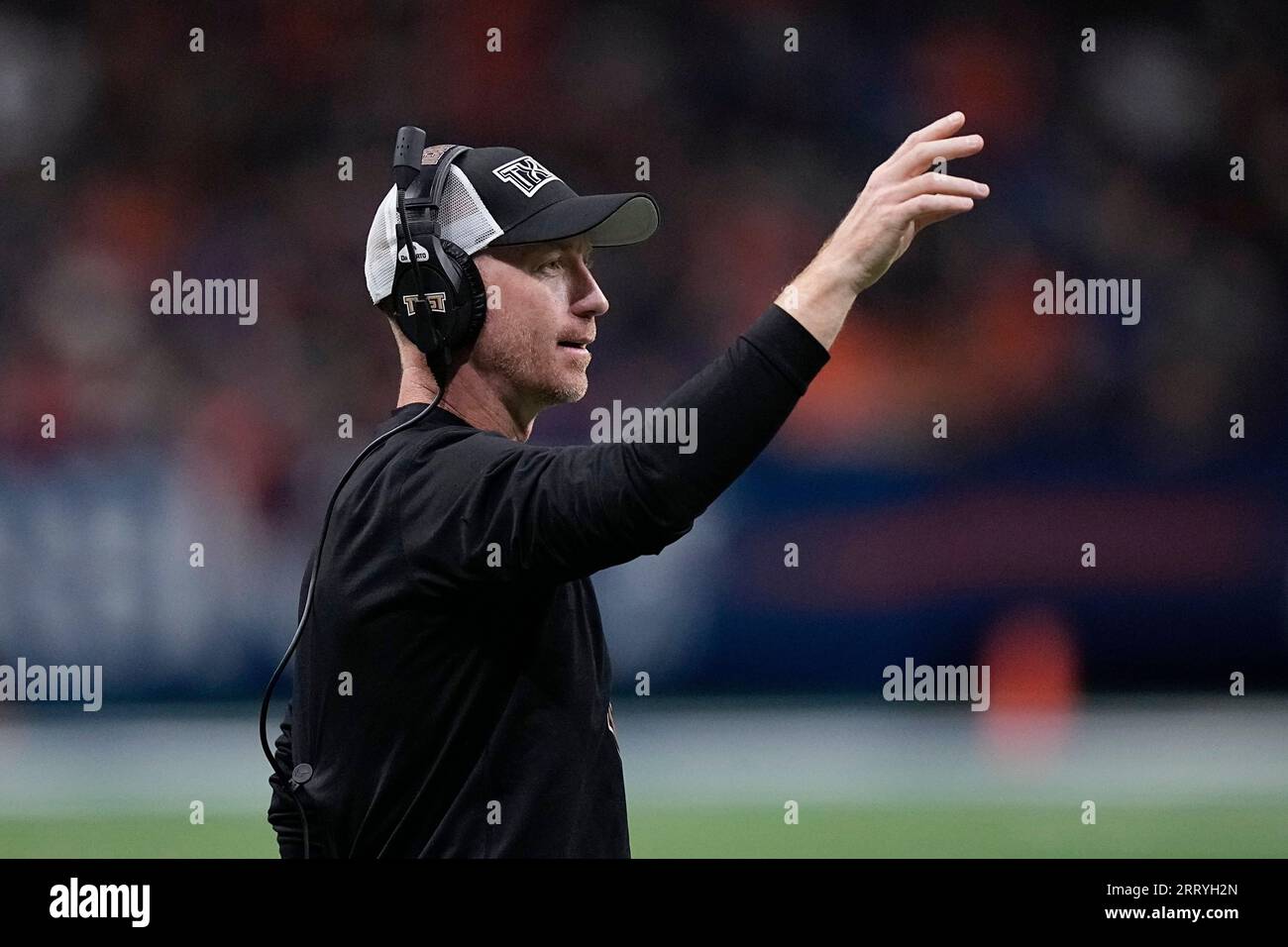 Texas State head coach GJ Kinne signals to his players during the first ...