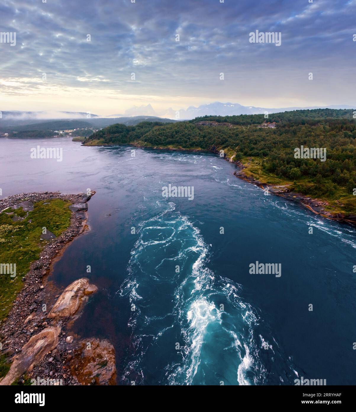 Fjord summer dusk landscape with flowing tidal current water. View from ...