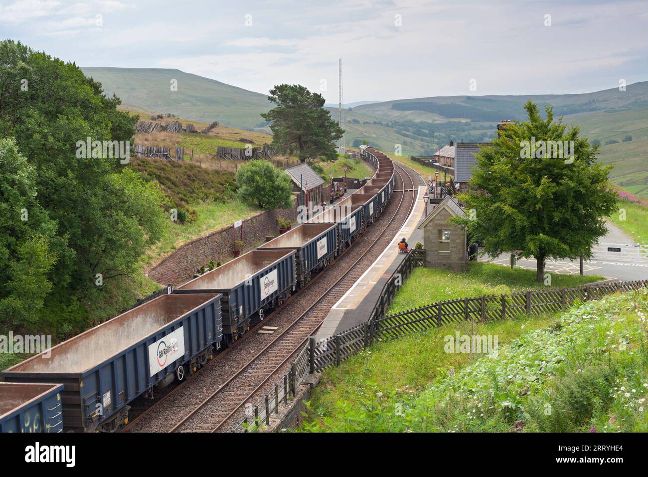 Freight train of empty bogie box wagons heading through Dent Railway ...