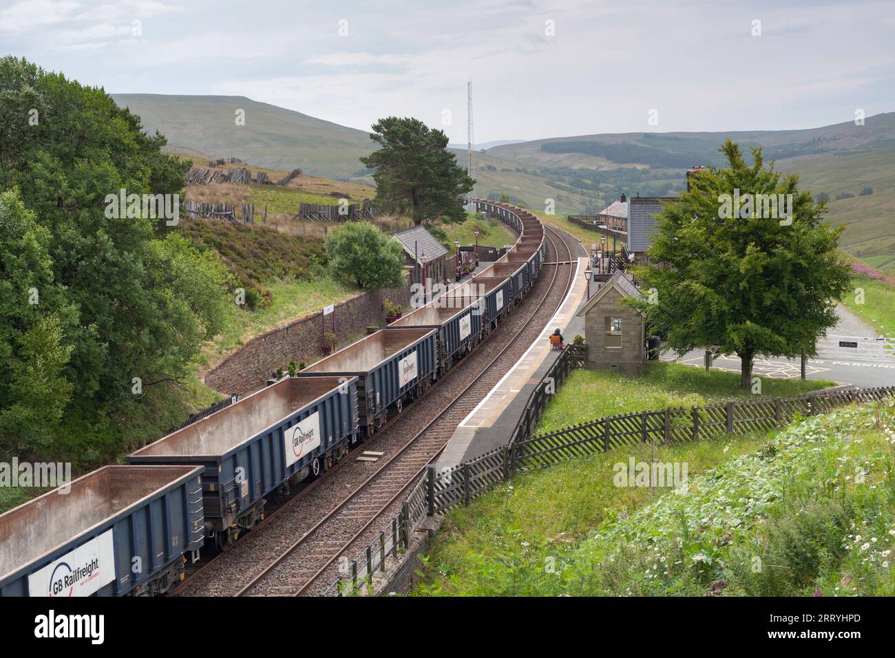 Freight train of empty bogie box wagons heading through Dent Railway ...