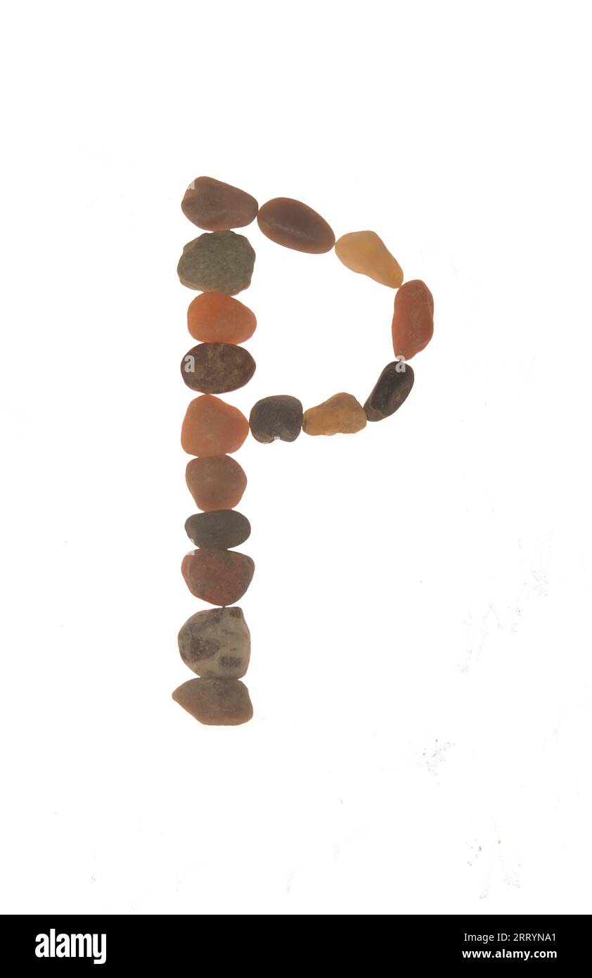 Letter P handcrafted using small stones or pebbles, single object ...