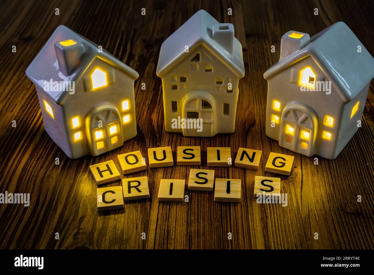 housing crisis in wooden letters ceramic house background, housing ...