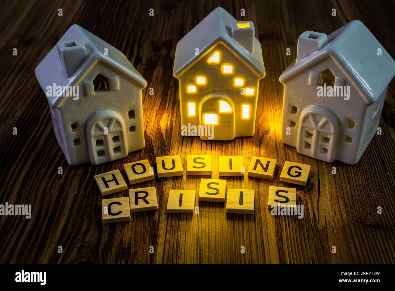 housing crisis in wooden letters ceramic house background, housing ...