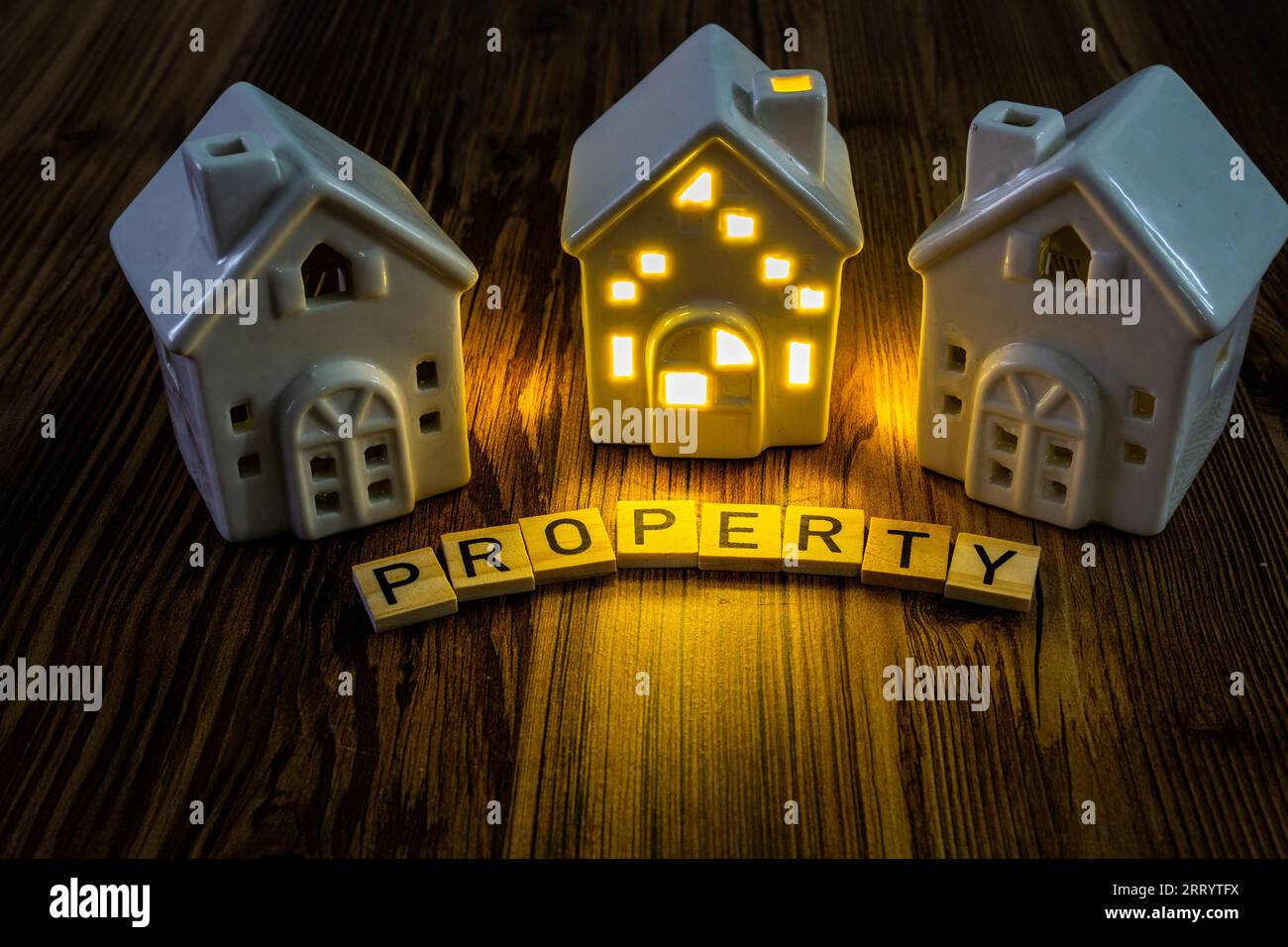 property sign in wooden letters ceramic house with light on housing ...