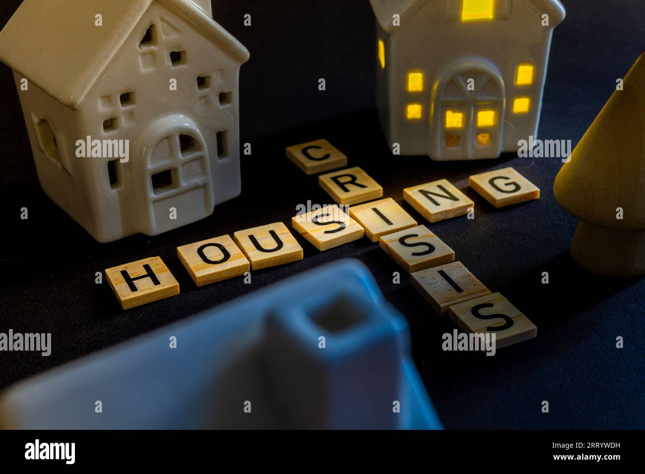 housing crisis in wooden letters crossword puzzle ceramic house with ...