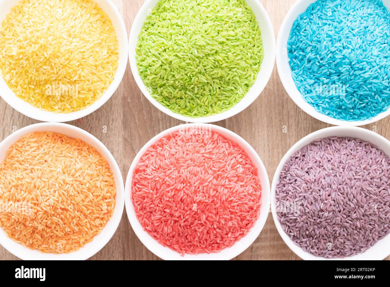 six pots of colored rice for sensory activities Stock Photo - Alamy