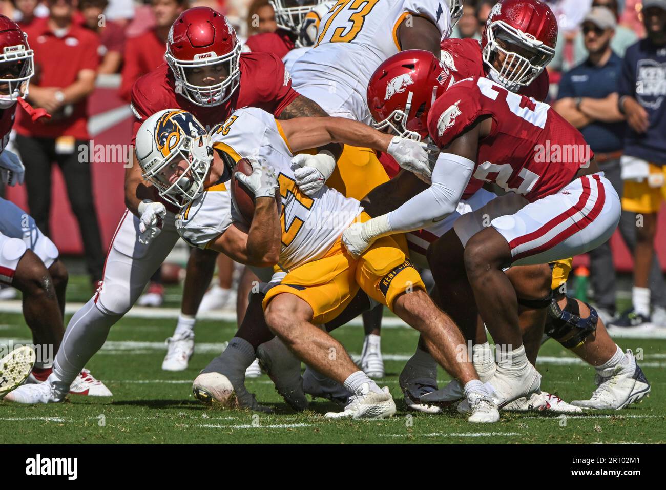 Kent State running back Gavin Garcia (21) is tackled by Arkansas ...