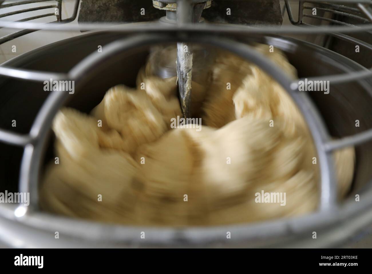 The running flour mixing machine is in the food processing plant, North ...