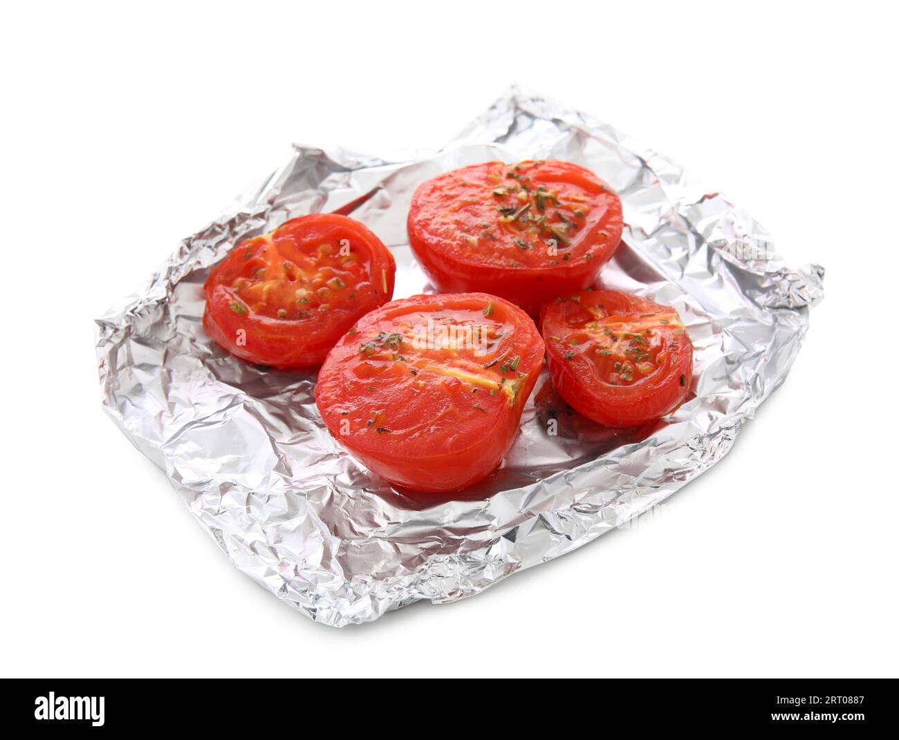 Aluminium foil with tasty baked tomatoes on white background Stock ...