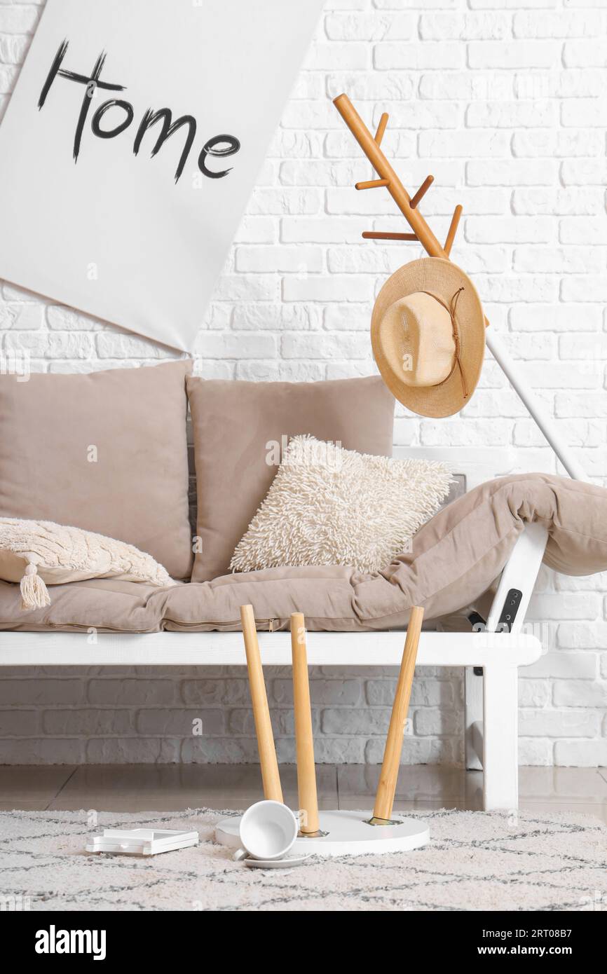 Couch with rack in messy living room Stock Photo - Alamy