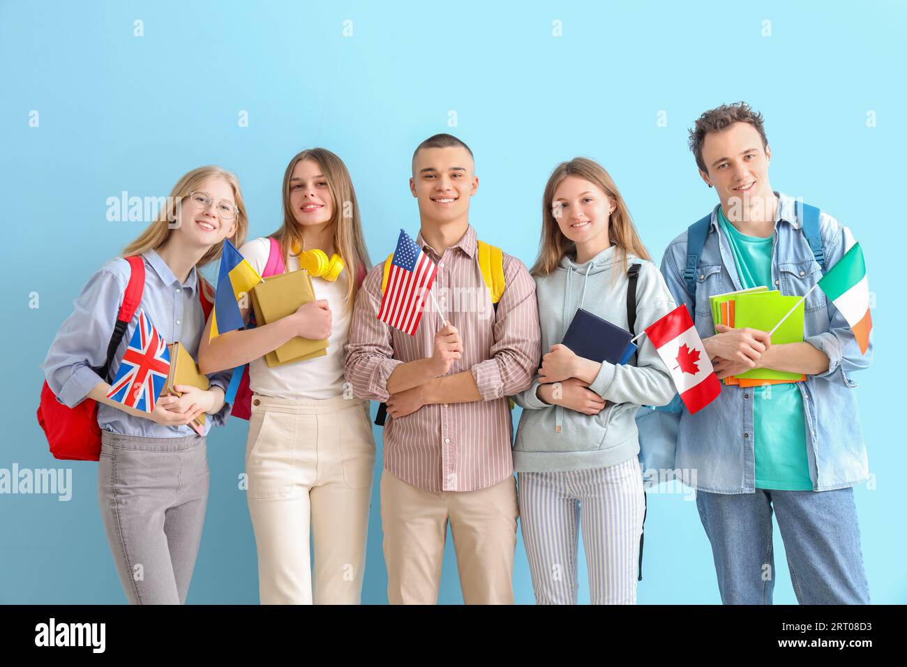 Group of students with books and flags of different countries on blue ...