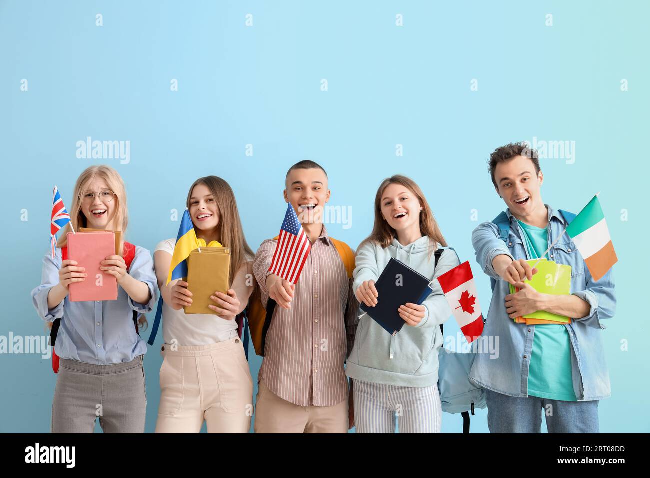 Group of students with books and flags of different countries on blue ...