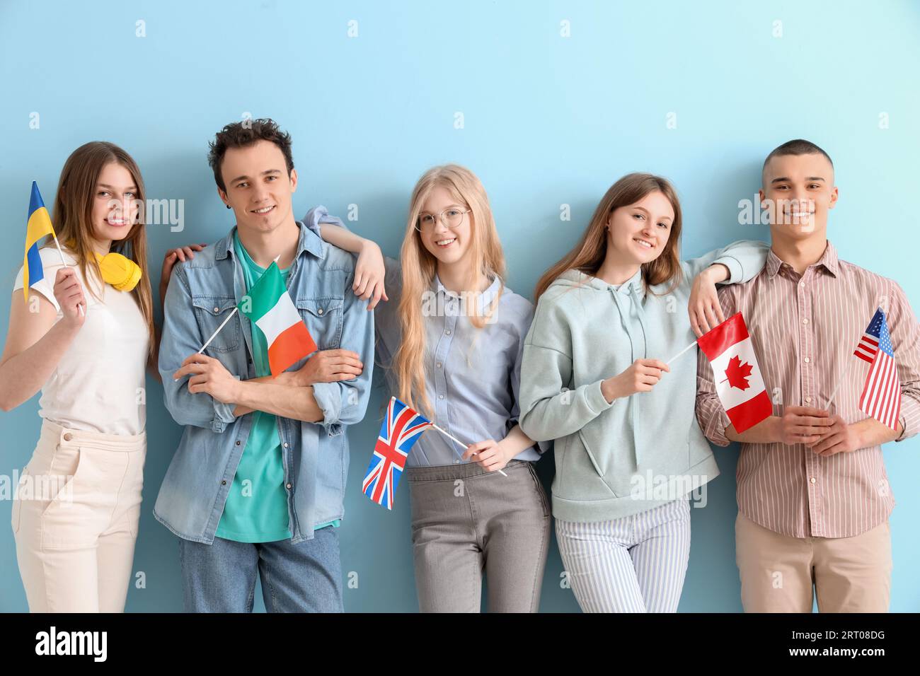 Group of students with flags of different countries on blue background ...