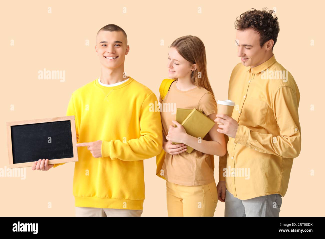 Group of students with books and blackboard on pale yellow background ...