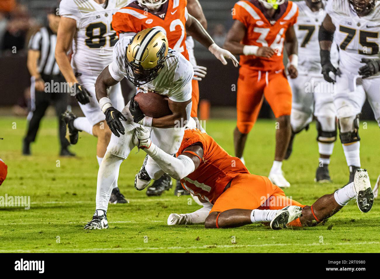 Purdue's Tyrone Tracy Jr. (3) with a nice run defended by Alan Tisdale (34) against Virginia ...