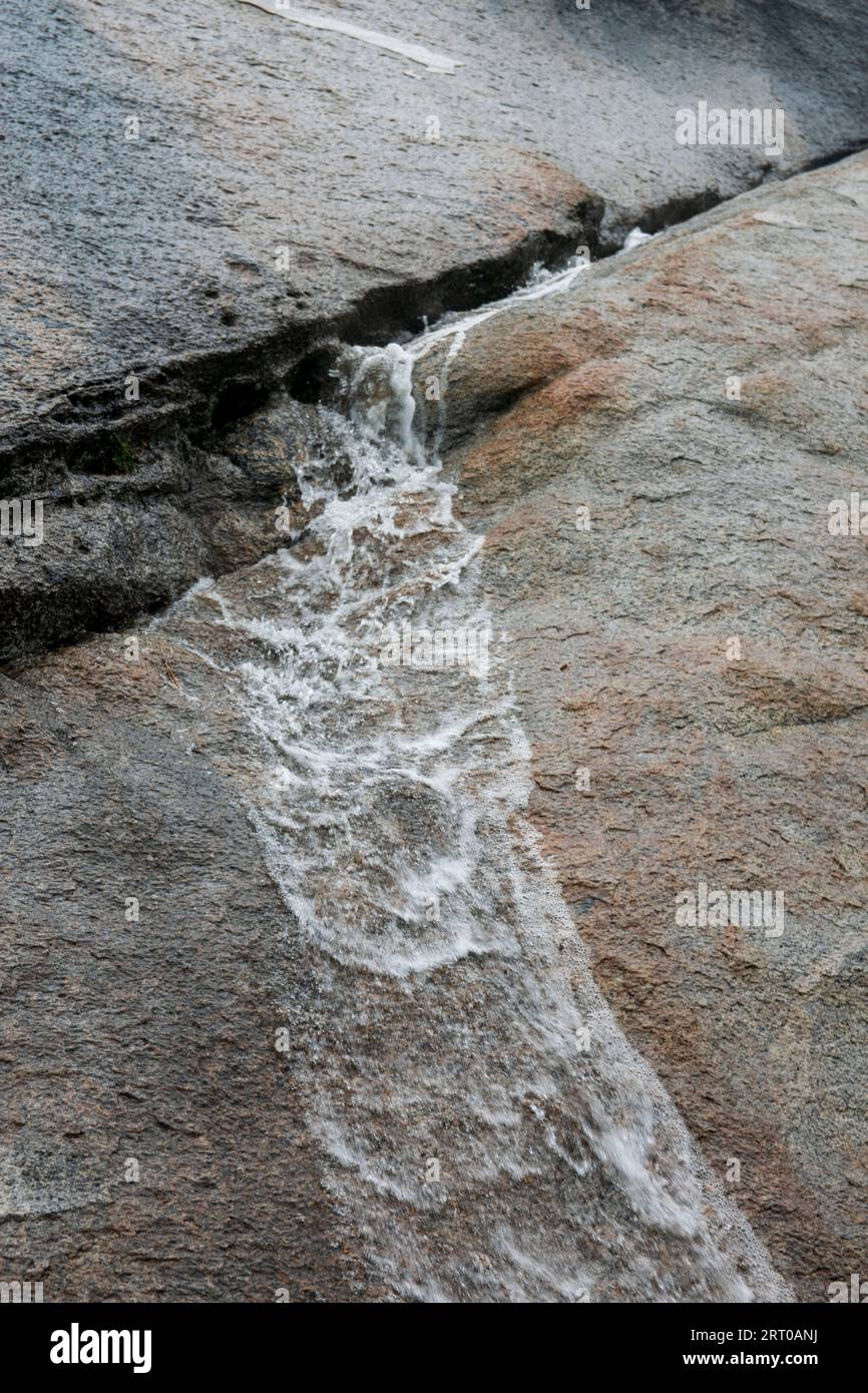 Temporary waterfalls form on the granite domes surrounding Tenaya Lake ...