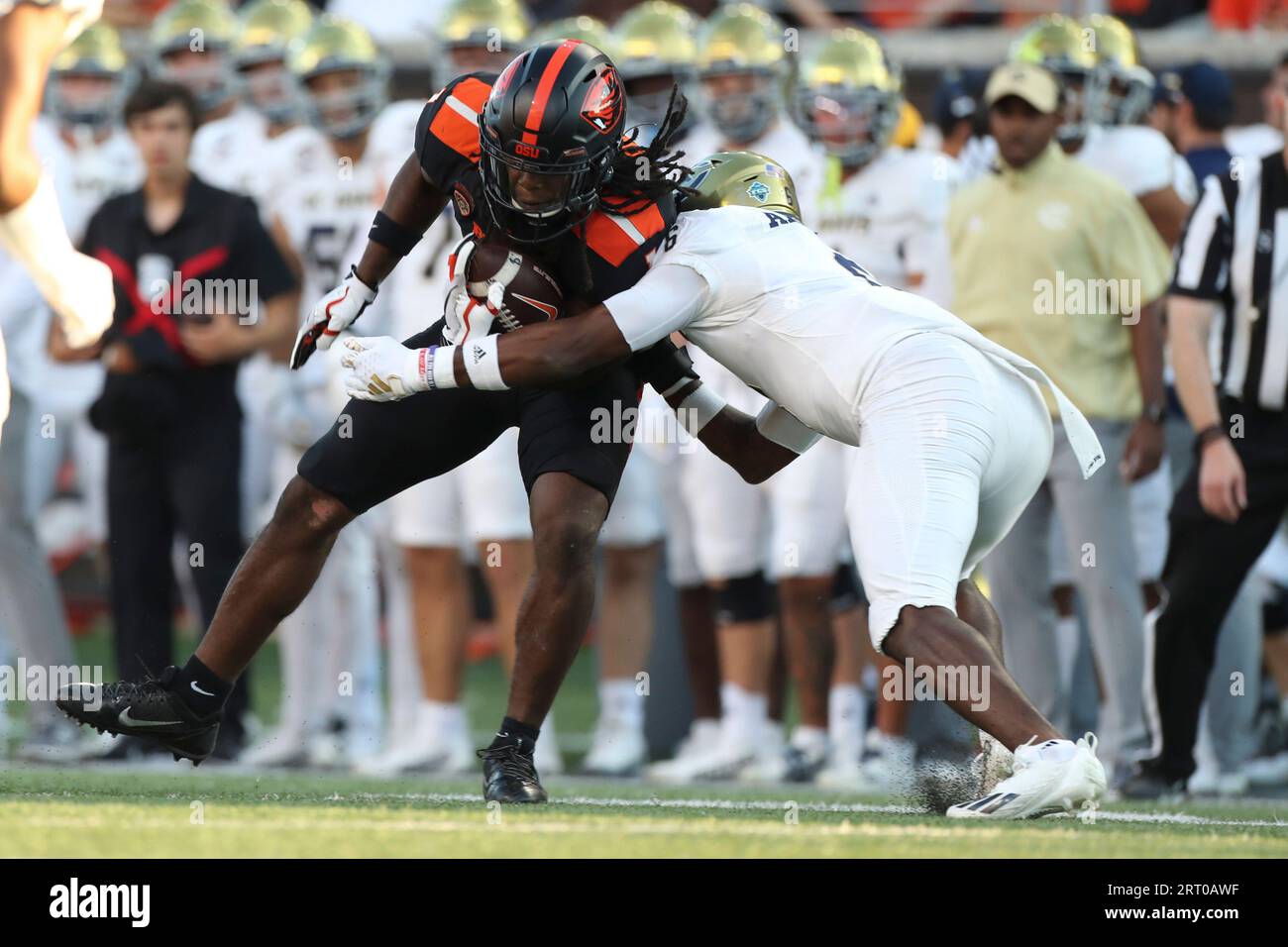 Oregon State running back Deshaun Fenwick, left, is brought down by UC ...