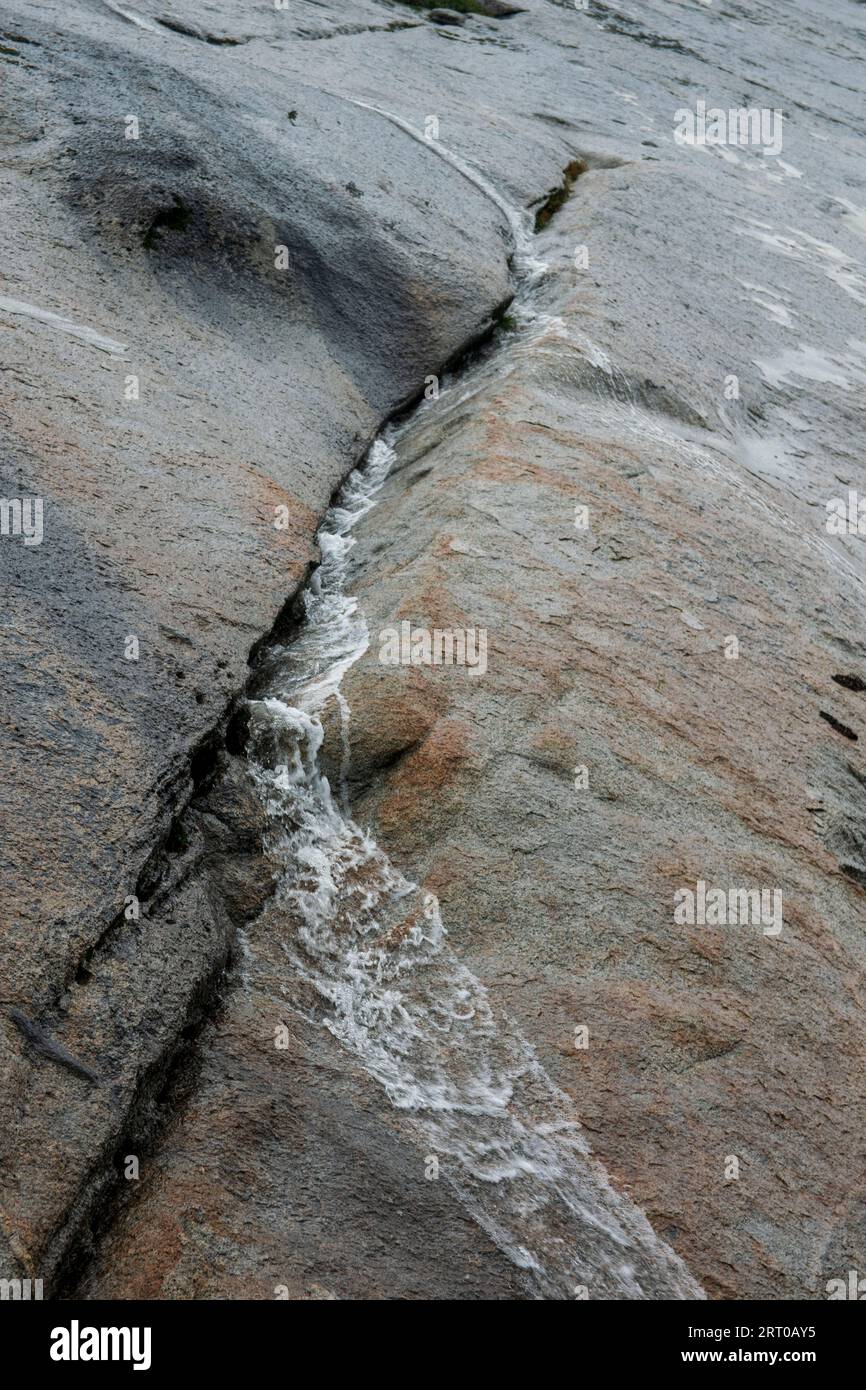 Temporary waterfalls form on the granite domes surrounding Tenaya Lake ...