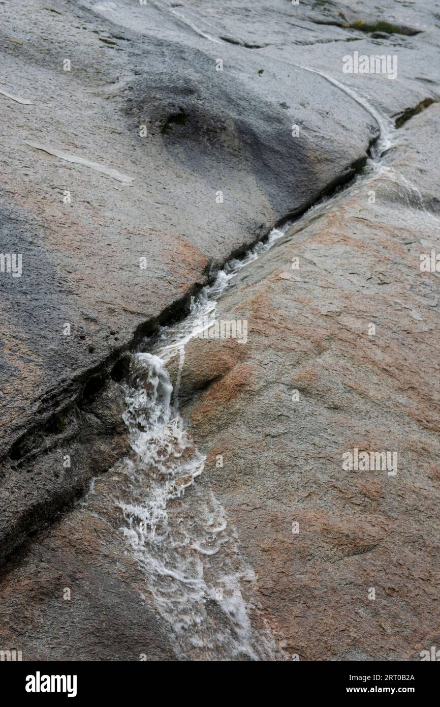 Temporary waterfalls form on the granite domes surrounding Tenaya Lake ...
