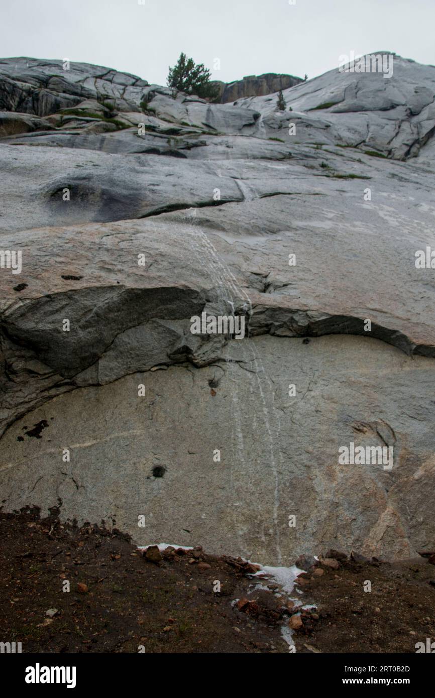 Temporary waterfalls form on the granite domes surrounding Tenaya Lake ...