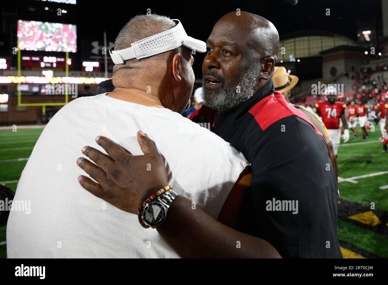 Maryland coach Mike Locksley, right, greets Charlotte coach Biff Poggi ...