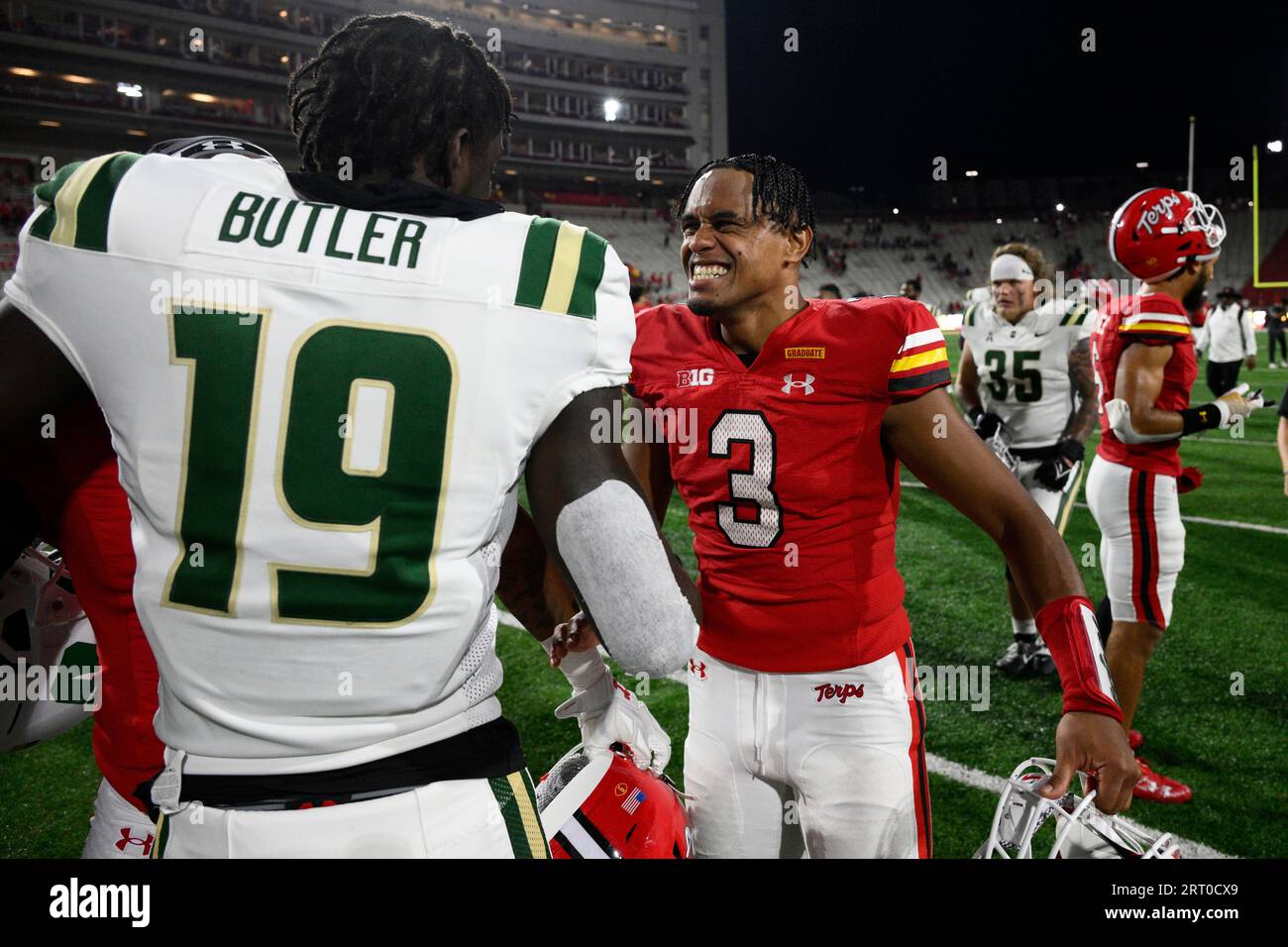 Maryland quarterback Taulia Tagovailoa (3) greets Charlotte linebacker ...