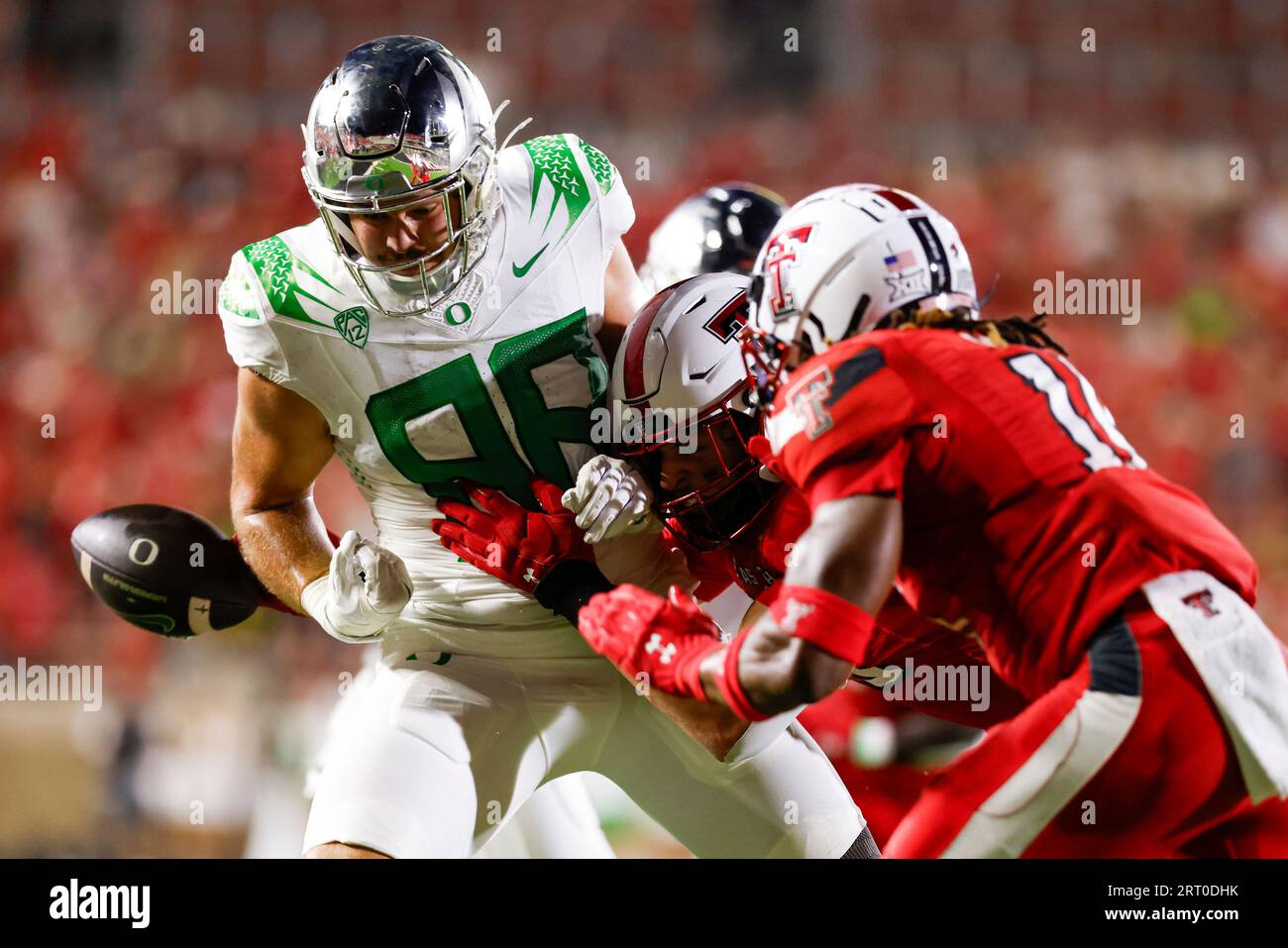 Oregon tight end Patrick Herbert (88) fumbles the ball after a hit from ...