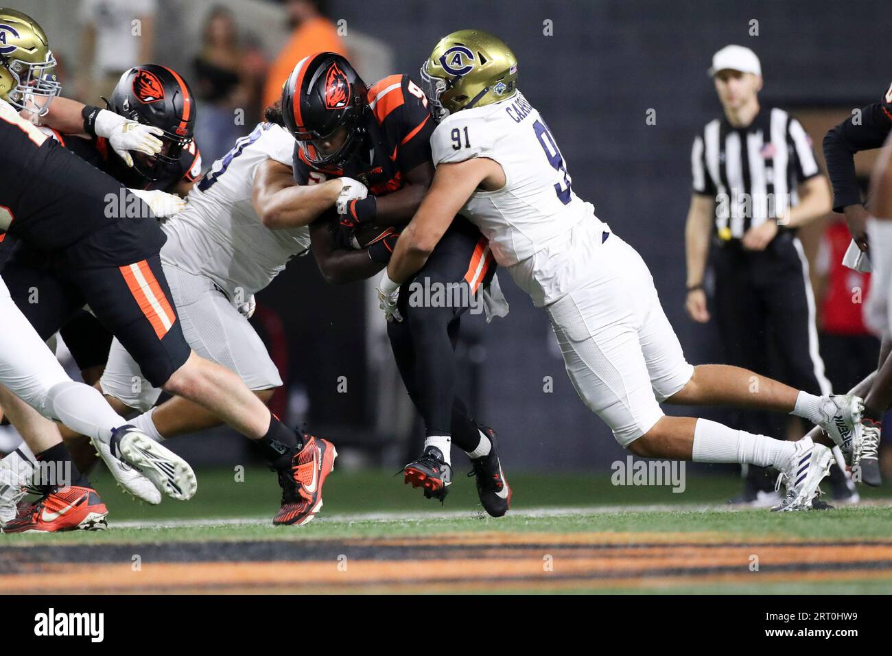 Oregon State running back Isaiah Newell, center is brought down by UC ...