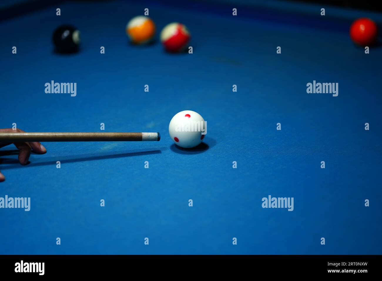 The hand holding the billiard cue, ready to make a precise strike on ...