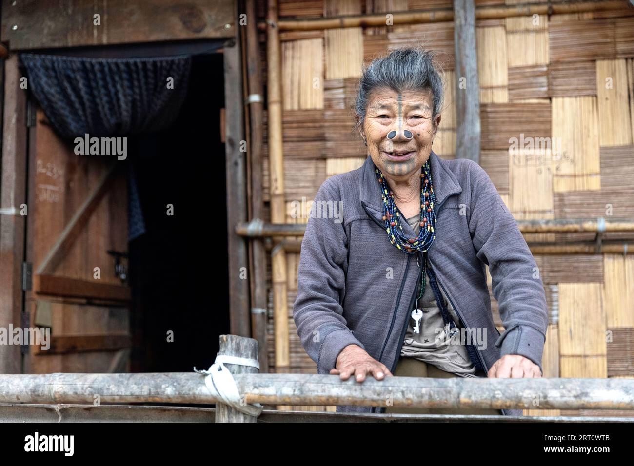 Woman from apatani tribe in a house from a small village near Ziro ...