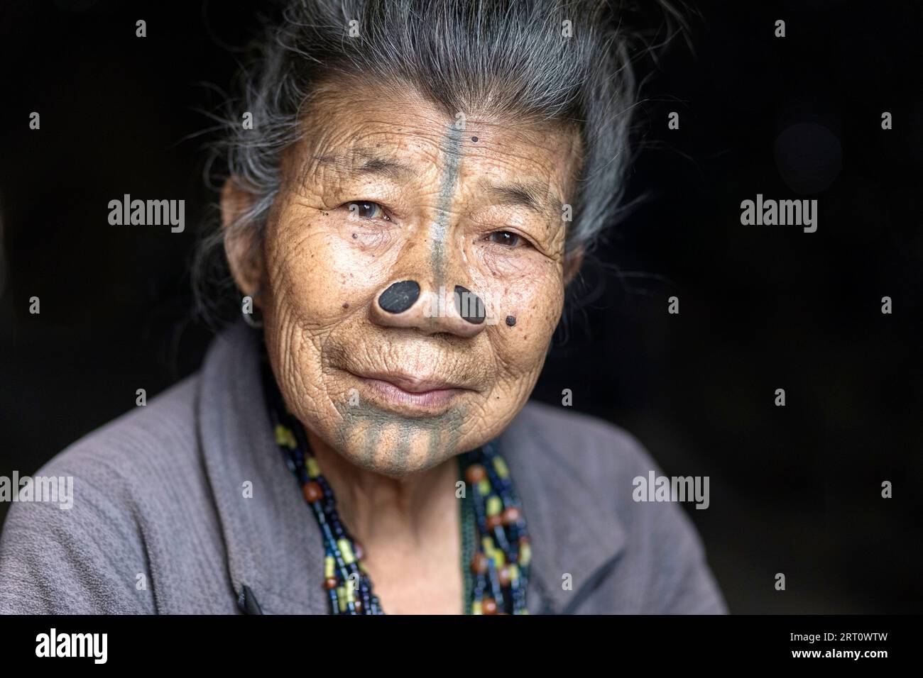 Portrait of elderly Indian Apatani ethnic minority tribal woman with ...
