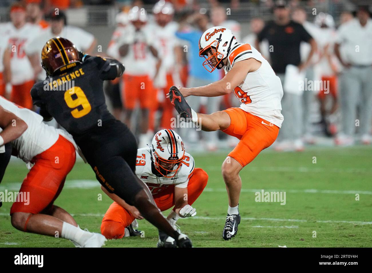 Oklahoma State place kicker Alex Hale, right, makes a field goal with the help from holder Wes ...