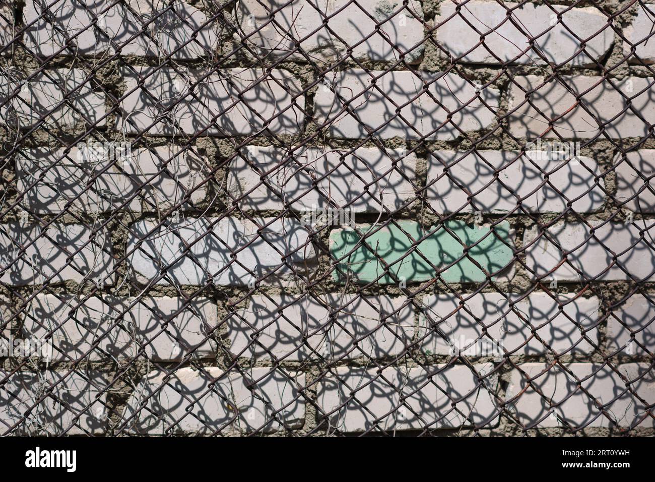 Rusty steel wire mesh on a brick wall. Background texture Stock Photo ...