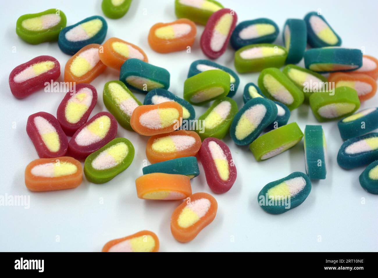 Interesting and unusual, colored caramel candies, sweets with a white ...