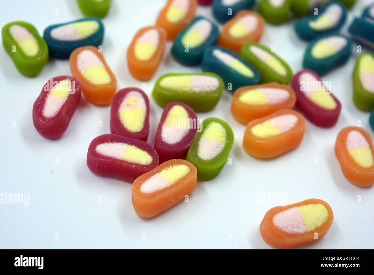 Interesting and unusual, colored caramel candies, sweets with a white ...