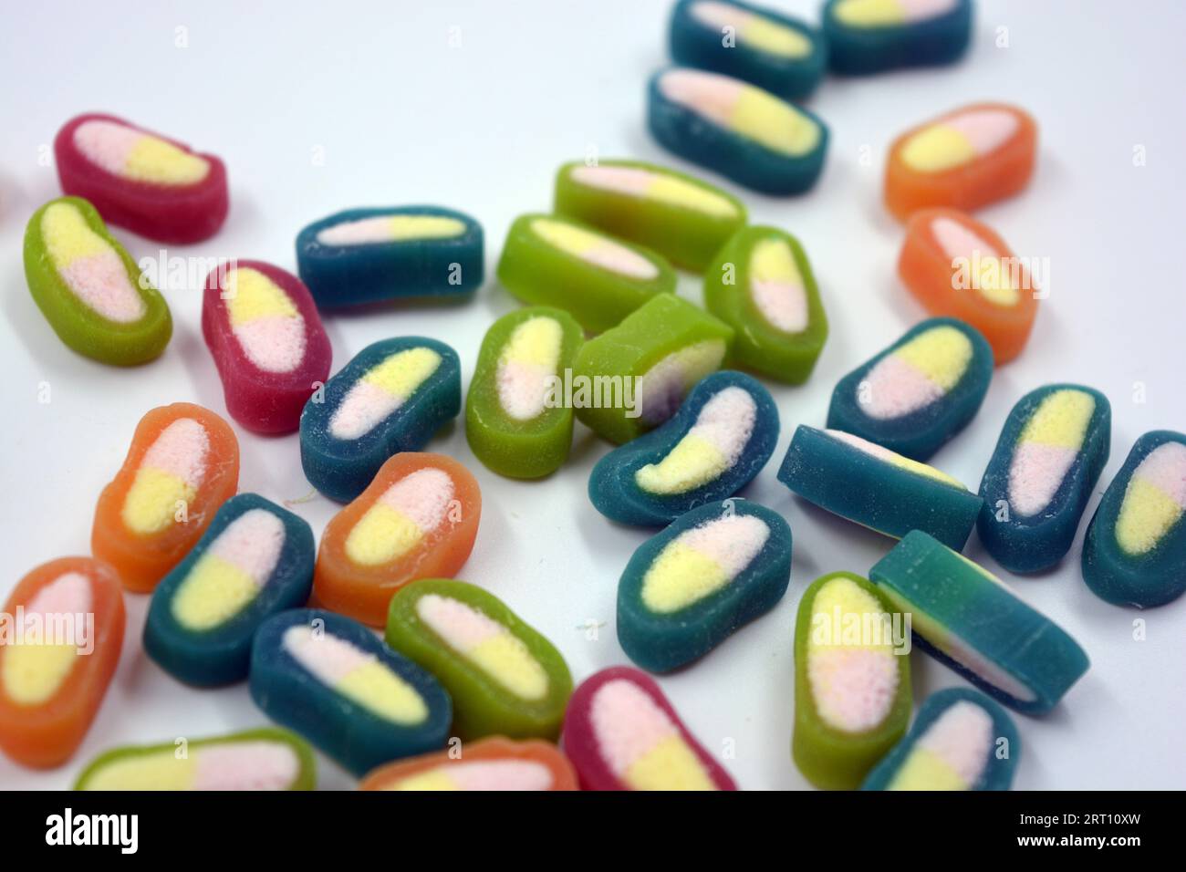 Interesting and unusual, colored caramel candies, sweets with a white ...