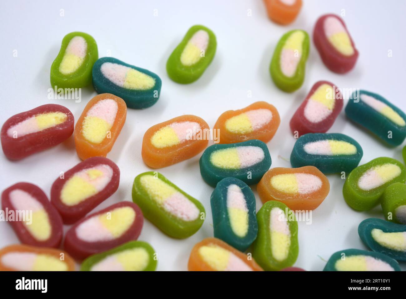 Interesting and unusual, colored caramel candies, sweets with a white ...