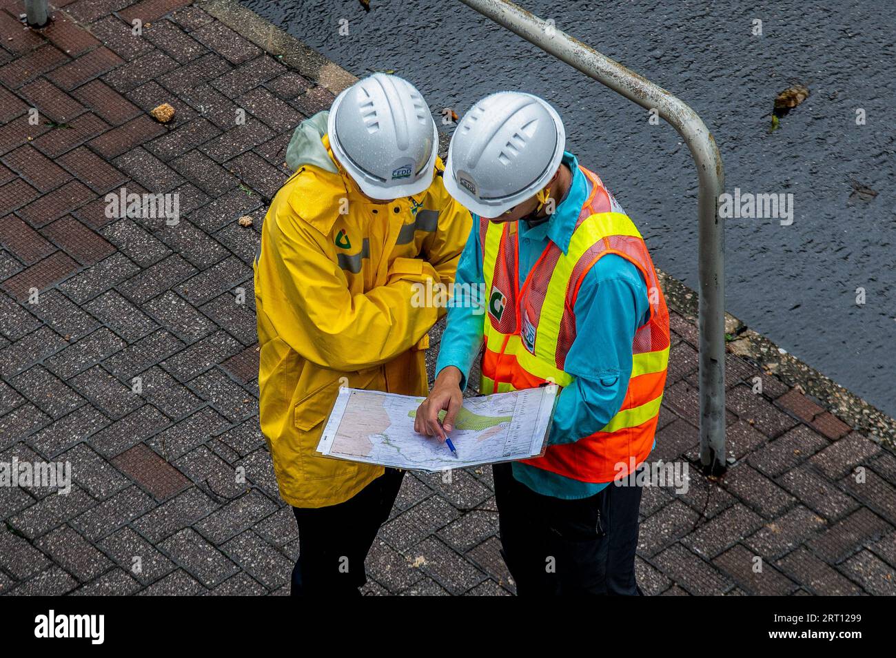 Workers from the Civil Engineering & Development Department review a ...