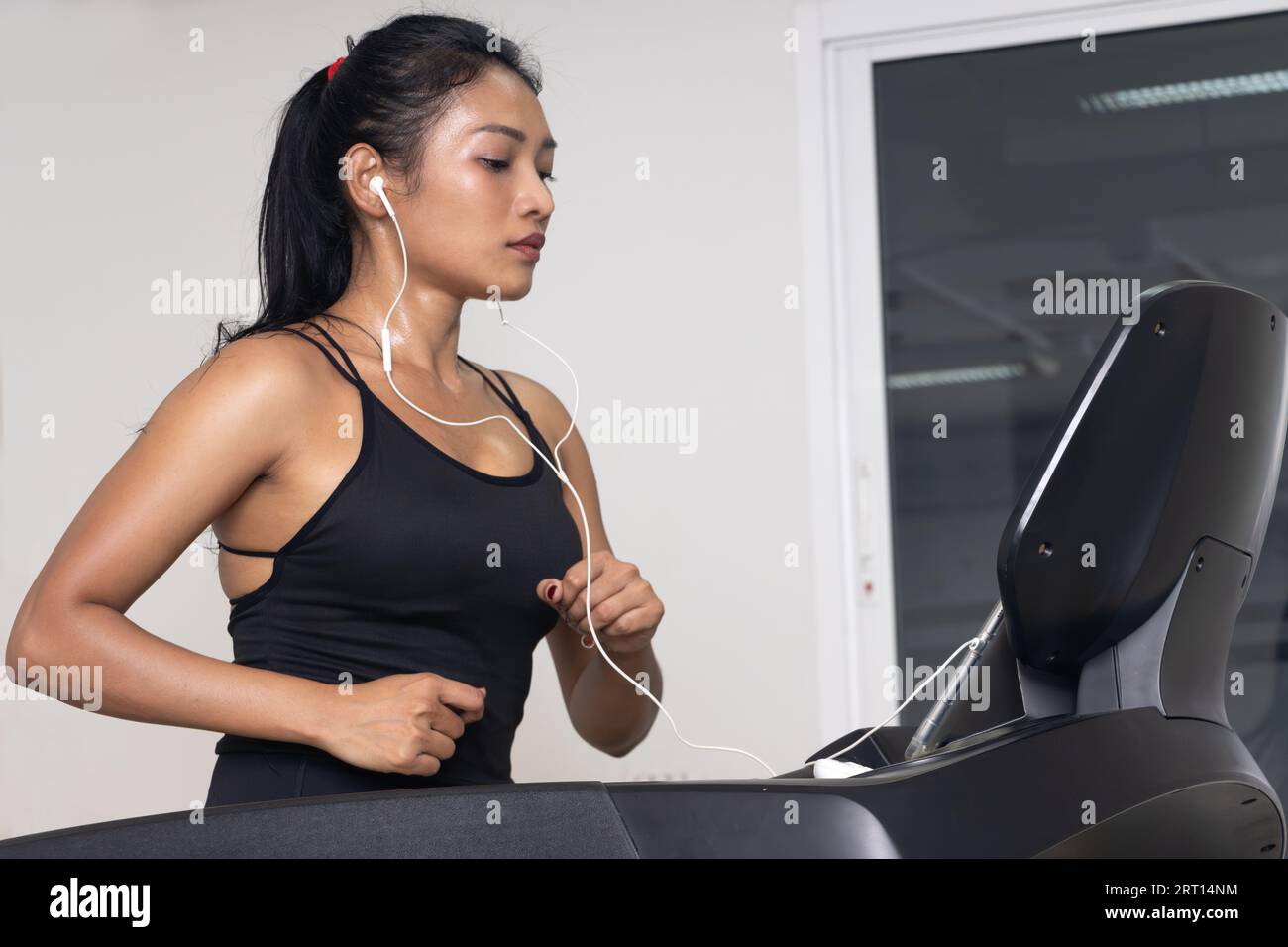 Sweaty woman running on a treadmill Stock Photo - Alamy