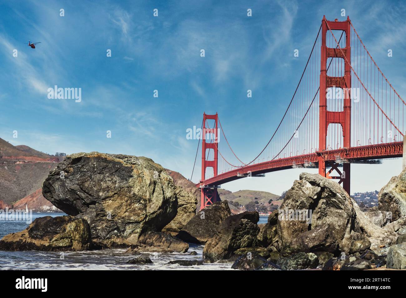 Helicopter Over Golden Gate Bridge Amidst Beautiful Clouds Stock Photo ...