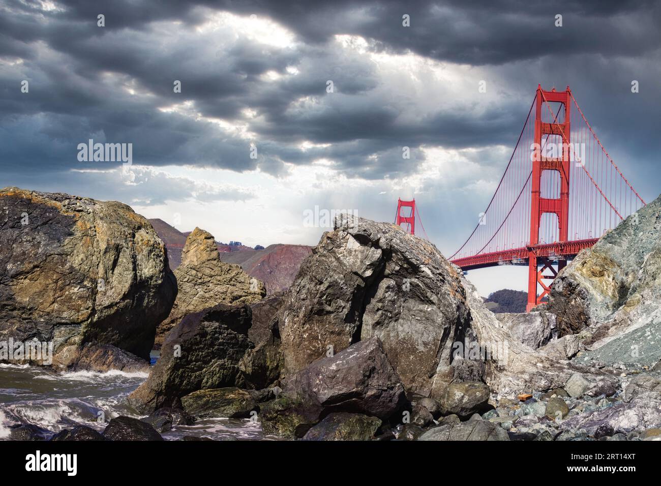Golden Gate Bridge Under a Dramatic Sunlit Cloudy Sky Stock Photo - Alamy