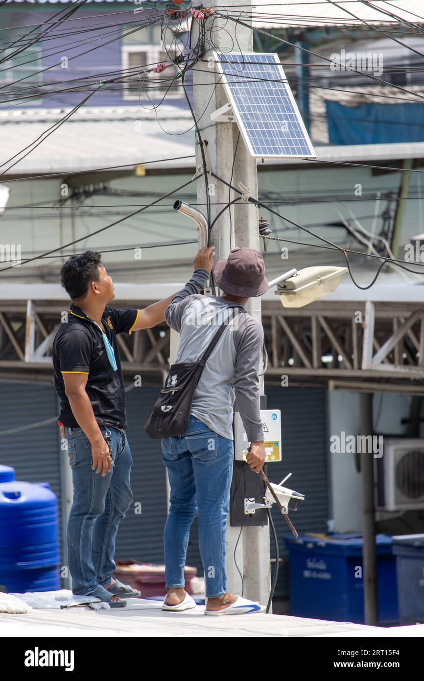 SAMUT PRAKAN, THAILAND, JUN 12 2023, Men install electrical equipment ...