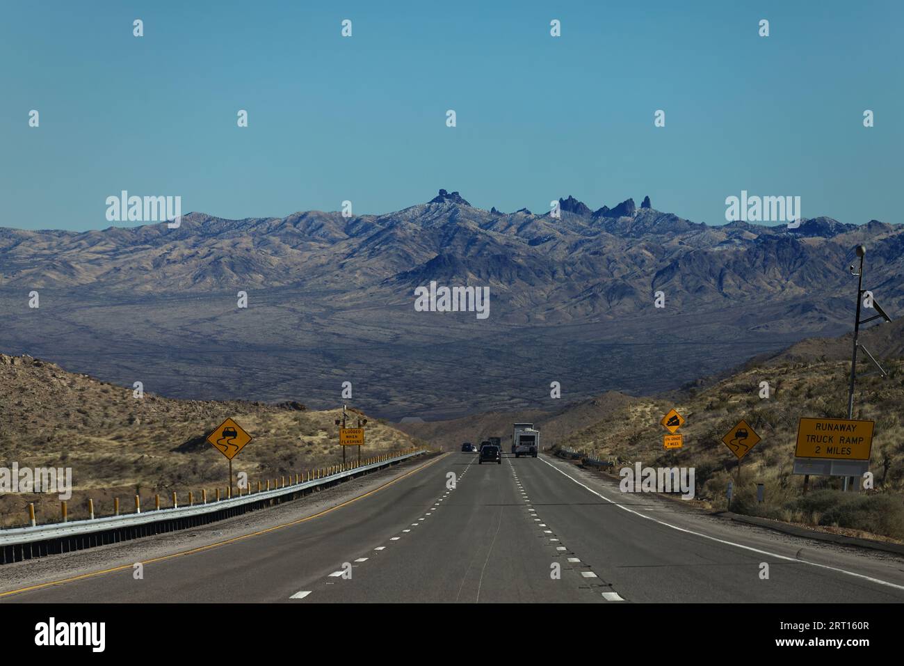 Scenic Drive: Cars on the Road with Mountain Backdrop Stock Photo - Alamy
