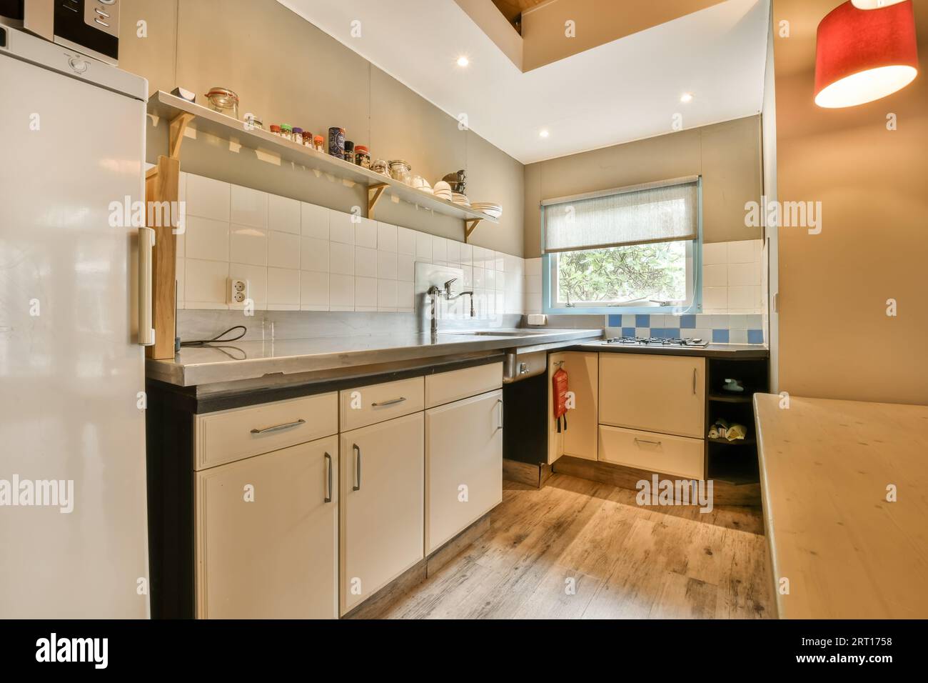 a kitchen with white cabinets and black counter tops in the center of ...