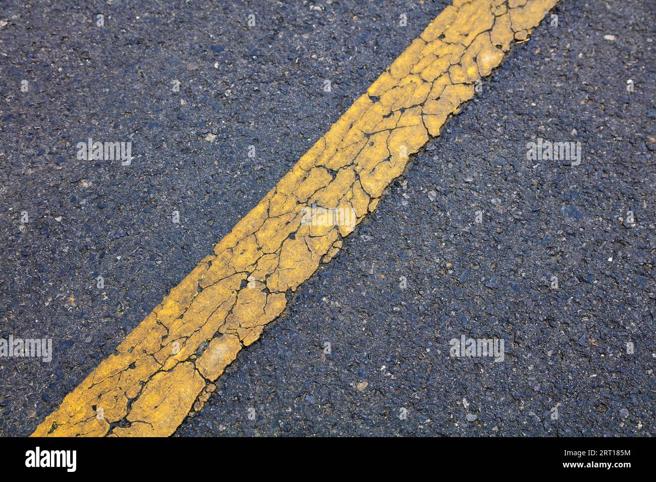 Yellow lines and crack in asphalt roads, closeup of photo Stock Photo ...