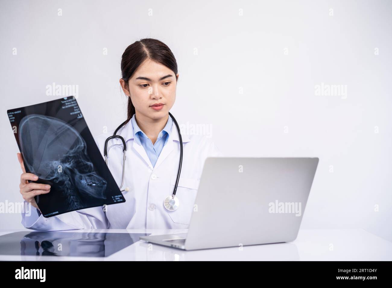 Female doctor checking x-ray film in medical laboratory at hospital ...