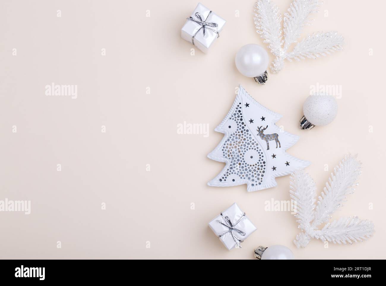 White Christmas ornaments on beige background, flat lay with copy space ...