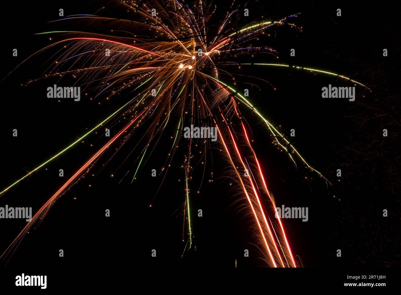 Explosion of a fireworks rocket, taken from below. With colorful light ...